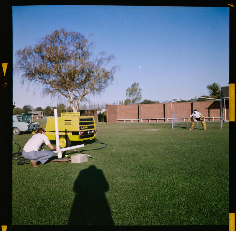 Film Negative: Atlas-Copco, hockey machine firing balls at goal keeper ...